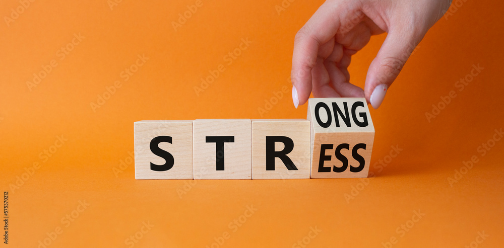 Strong Stress symbol. Businessman Hand turns cubes with words Strong ...