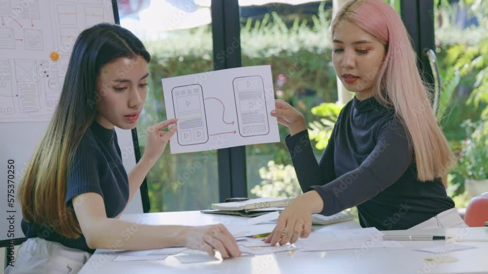Female ux developer and ui designer brainstorming about mobile app ...