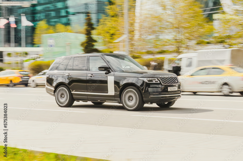 car Range Rover L405 in motion, side view. Sport SUV black color ...