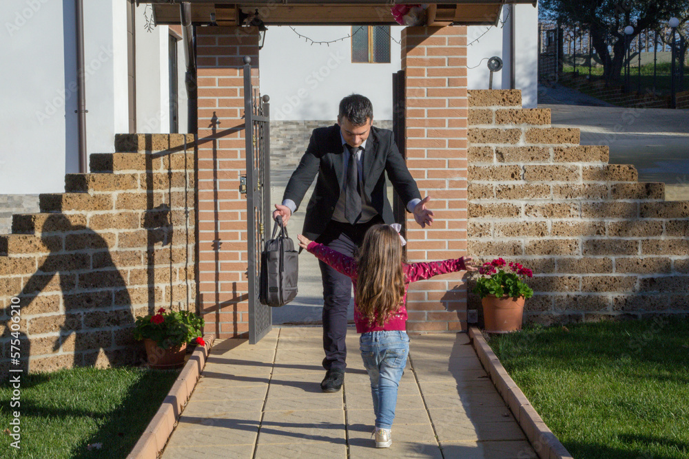 Image of an adorable little girl running to her dad to hug him and ...