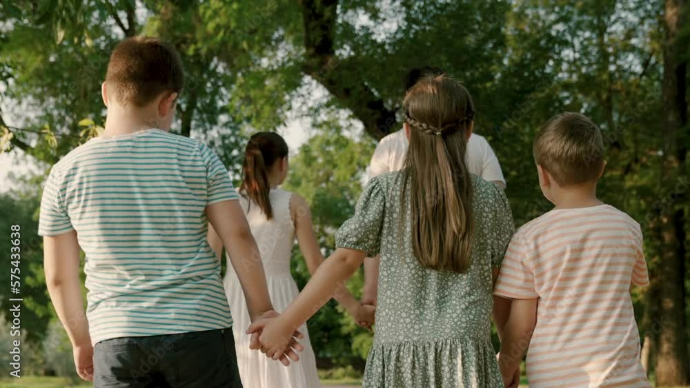 Children, parents together on walk. Big happy family is walking through ...