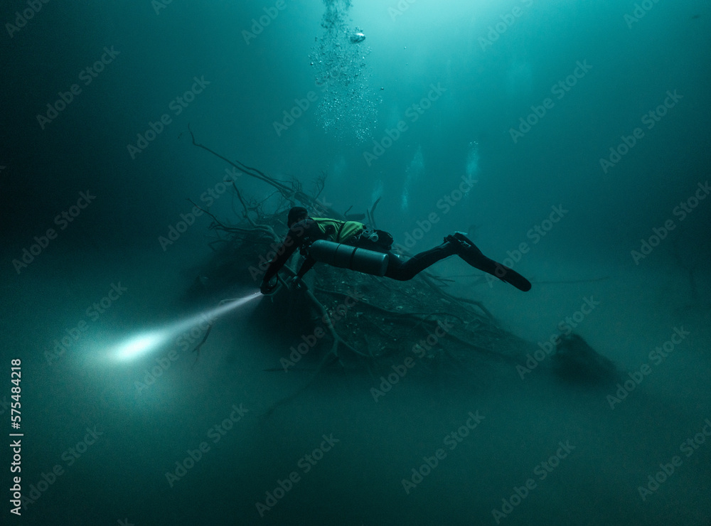 Poster technical diver diving above a halocline in angelita cenote ...