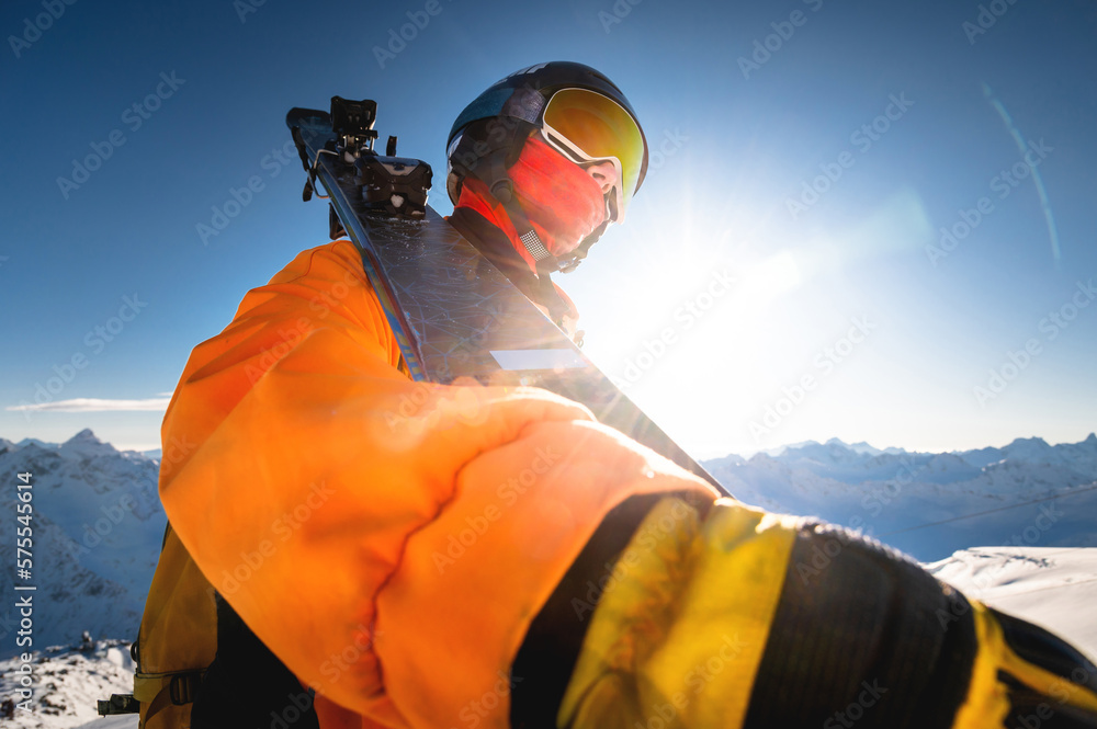 Portrait of a skier against the backdrop of the snow-capped mountains ...
