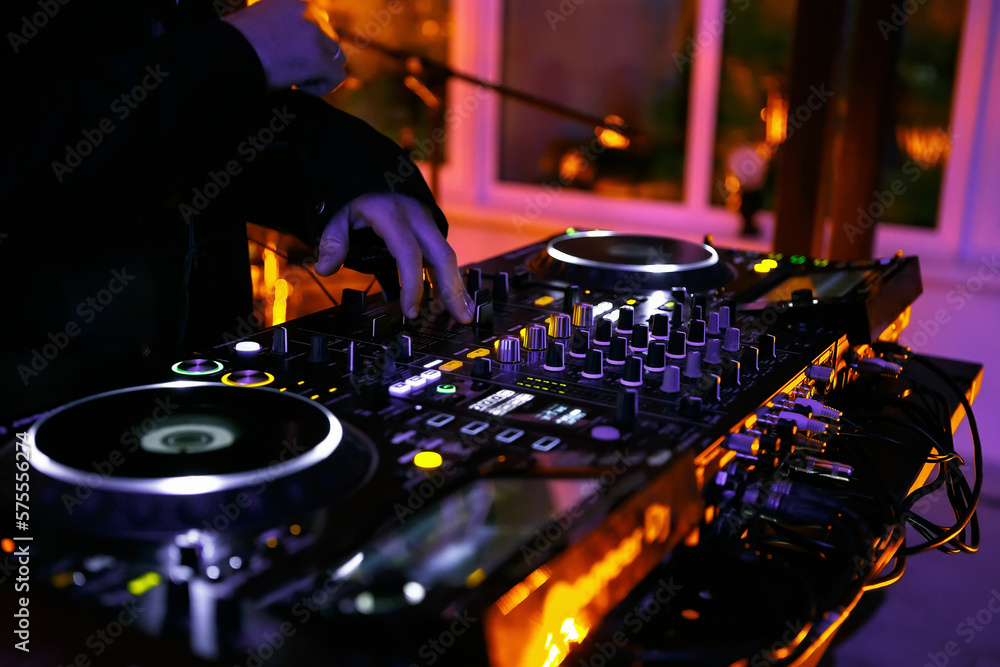 DJ girl playing music on party in night club. Hands of female disc ...