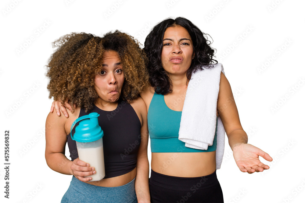 Two best friends are ready to go to the gym, one of them holds a ...