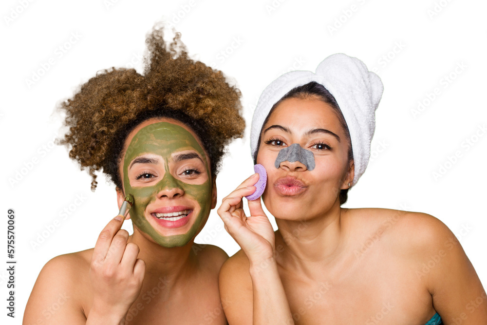 Two friends pamper themselves with facial treatments for a relaxing spa ...