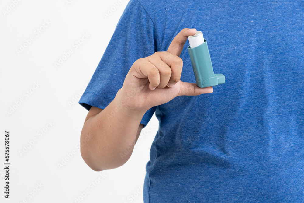 Asian boy using blue asthma inhaler for relief asthma attack. Medicinal ...