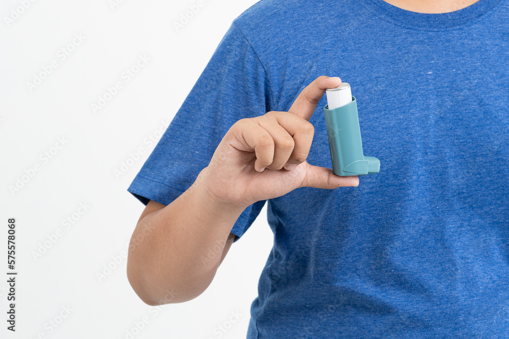 Asian boy using blue asthma inhaler for relief asthma attack. Medicinal ...