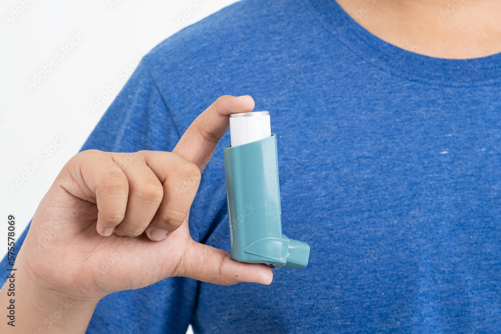 Asian boy using blue asthma inhaler for relief asthma attack. Medicinal ...