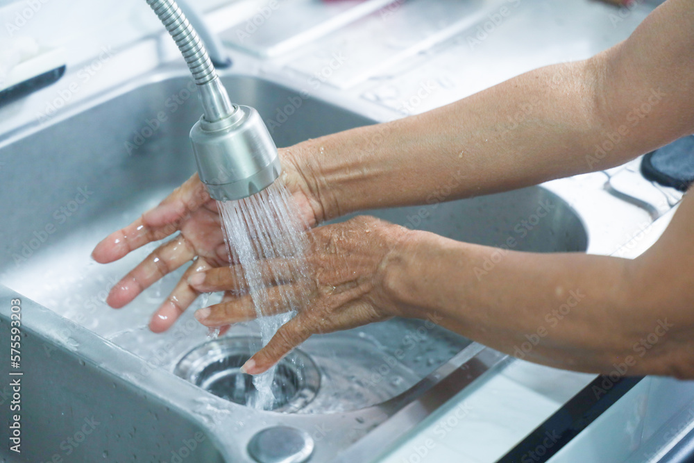 Elderly woman hands washing. Hand hygiene to prevent infection. Take ...