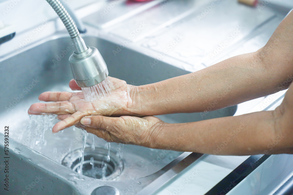 Elderly woman hands washing. Hand hygiene to prevent infection. Take ...