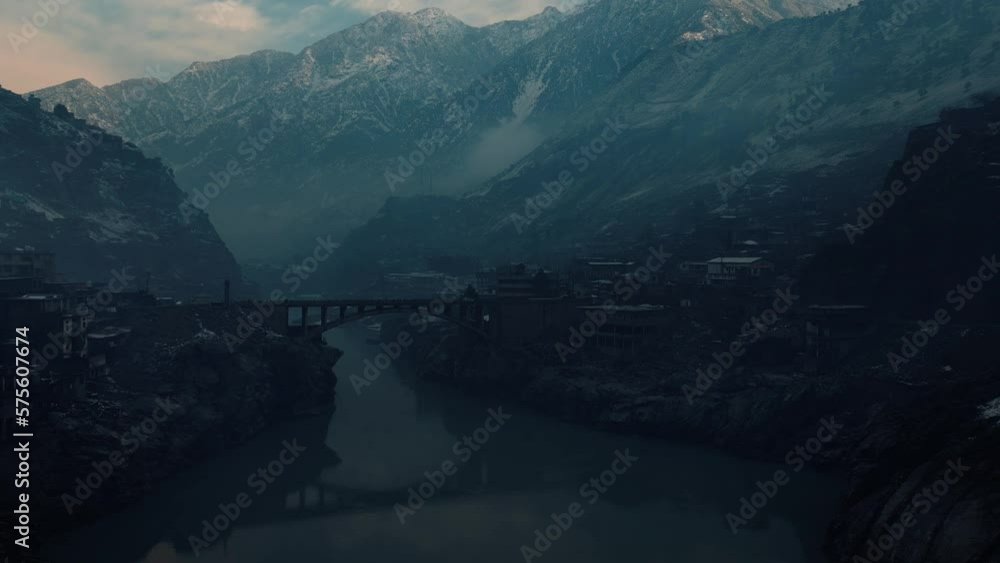 Drone passing under a bridge and reveal an aerial view of Komila, Upper ...