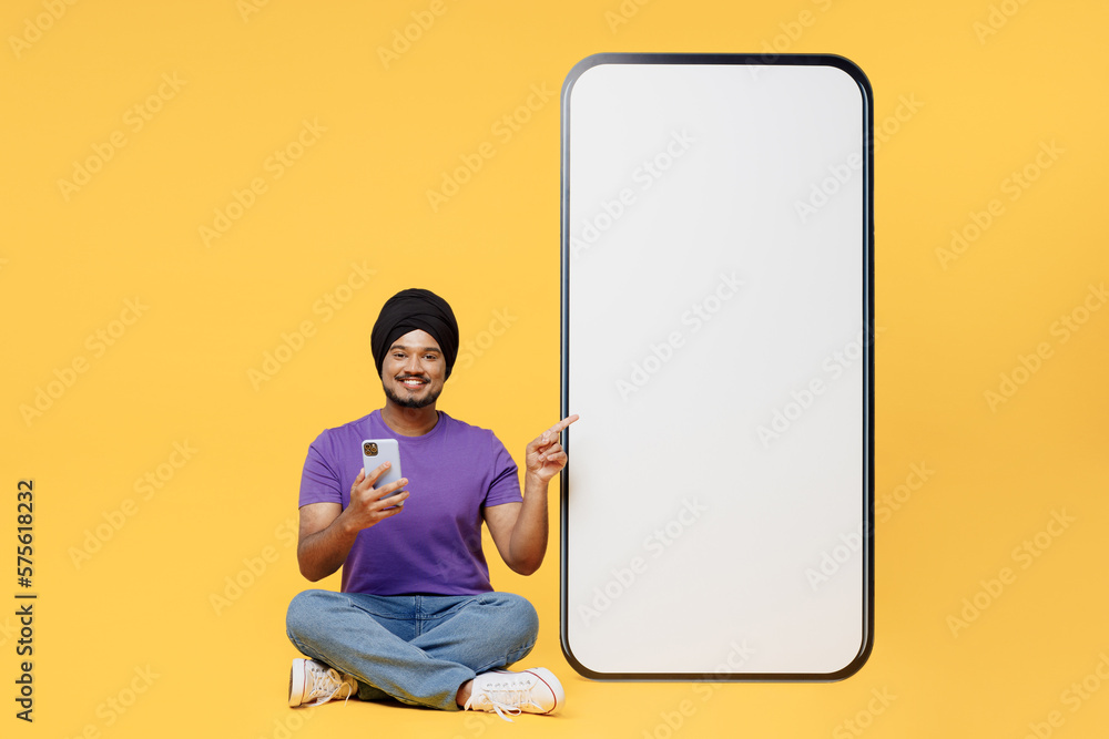 Full body devotee Sikh Indian man tie his traditional turban dastar ...