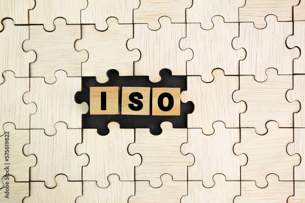wooden puzzle with the letter ISO. the concept of standardization. ISO ...