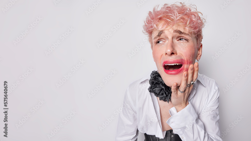 Sad crying man has dolesful expression has spoiled makeup bad mood ...