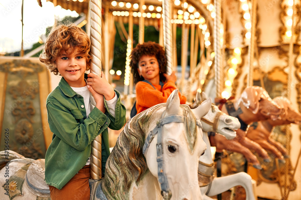 Kids having fun on a carnival Carousel Stock Photo | Adobe Stock