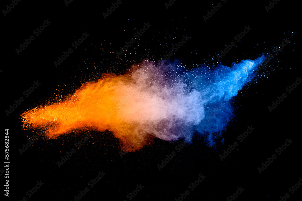 Blue orange color powder explosion cloud on black background. Closeup ...