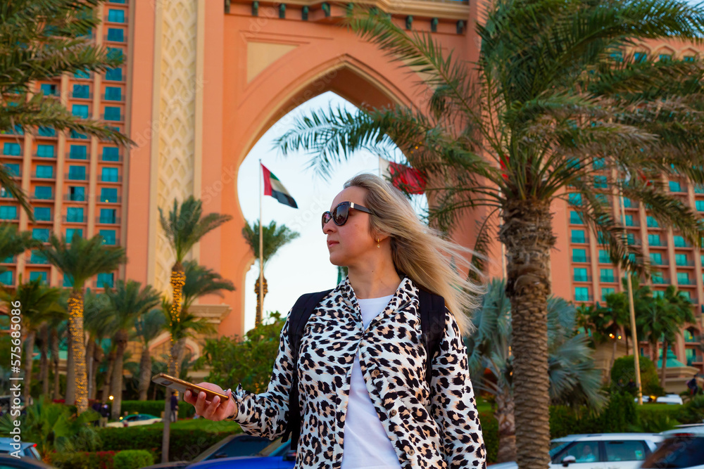 Amidst modern architecal designs, a stunning blonde woman in Dubai, UAE ...