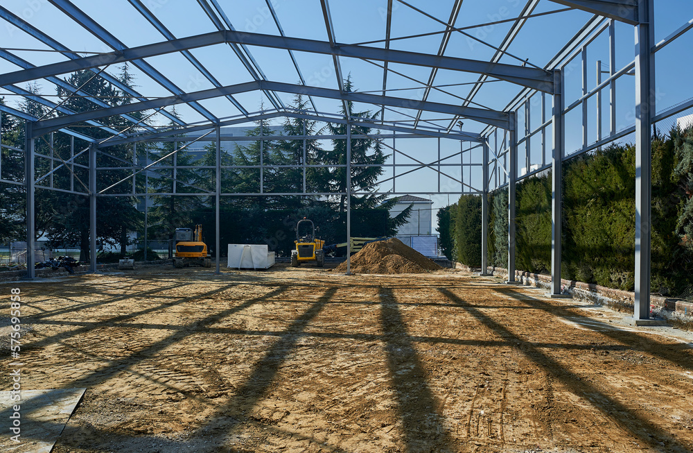 Metallic structure with pillars, beams, sand and heavy machinery to ...