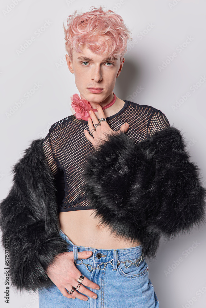 Vertical shot of serious pink haired non-binary person has feminine ...