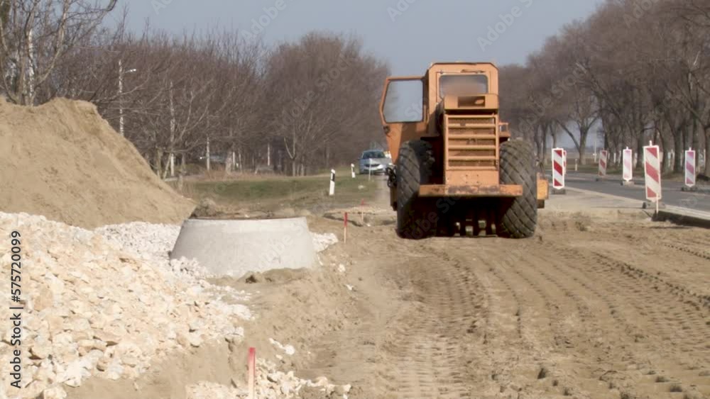 Video Stock Bulldozer bucket moves earthen pile, flattens the surface ...