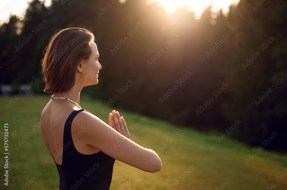 Meditate young woman standing on Sadhu nail board with closed eyes ...