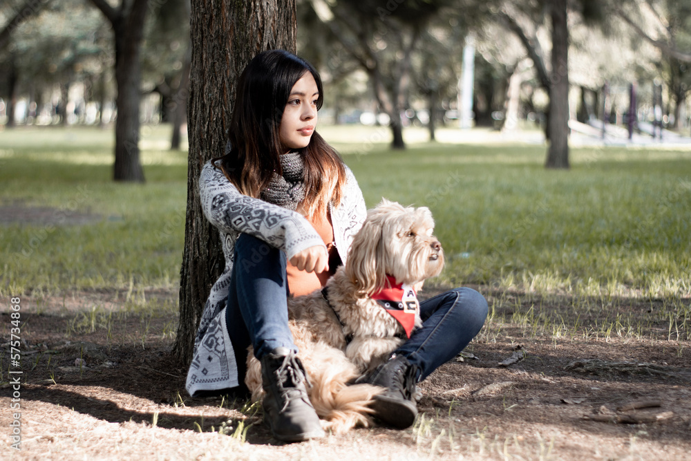Girl and her dog. A girl is looking into the distance together with her ...