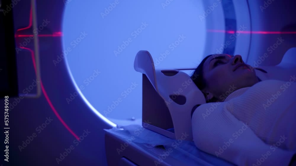 4k video CT scan of brains of woman in medical clinic with blue light ...