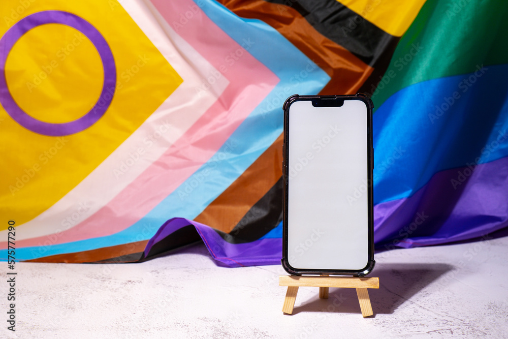 Stockfoto Mobile phone with white screen for copy space on Rainbow ...