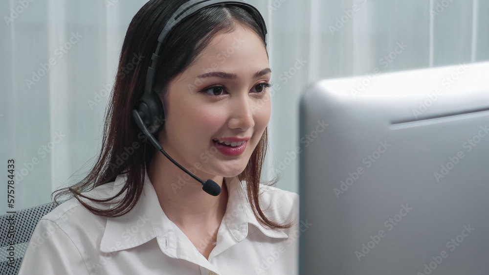Asian customer support operator wearing headset and microphone working ...