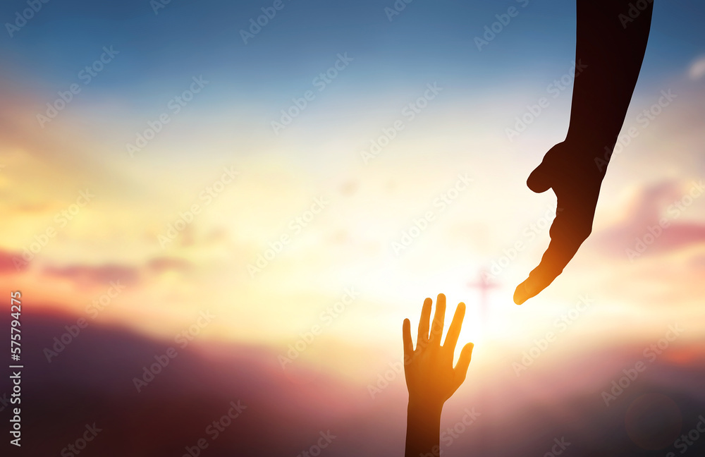 religious concept,God's helping hand and cross on sunset background ...