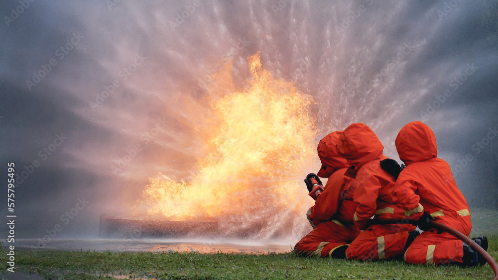 Firefighter Rescue team training in fire fighting extinguisher ...