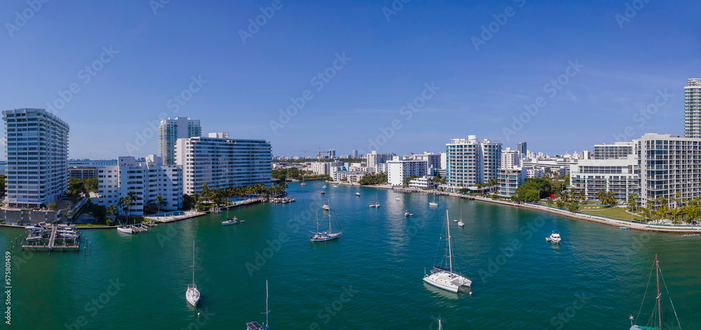 Boats on the blue intracoastal waterway between modern buildings in ...
