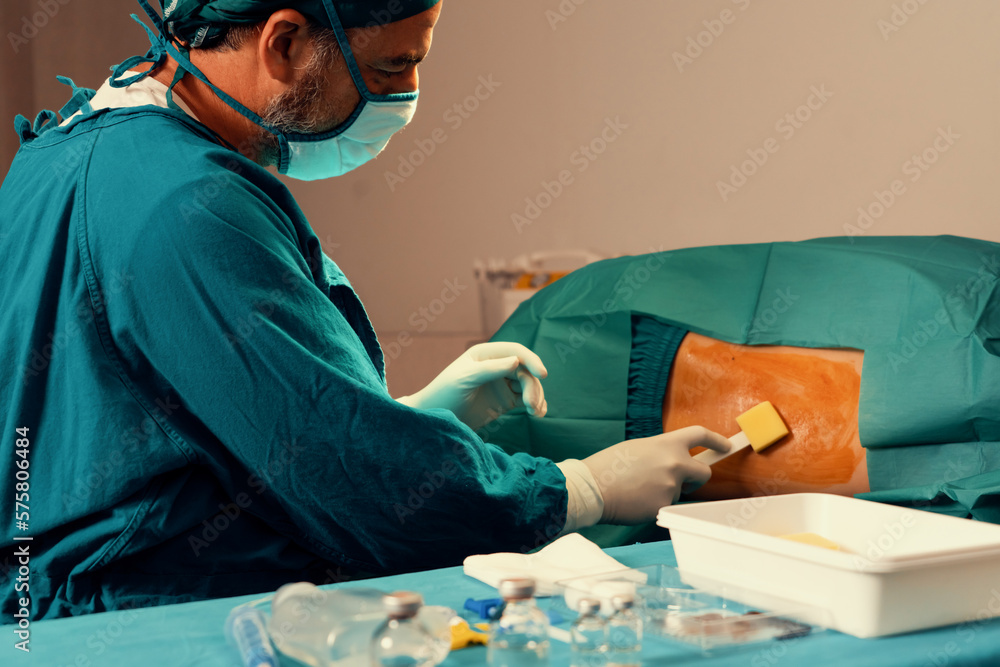 Doctor or surgeon apply betadine to the patient for anesthesia ...