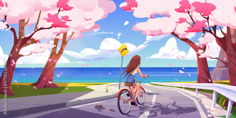 Girl riding bike on japanese road near coast through sakura forest with ...