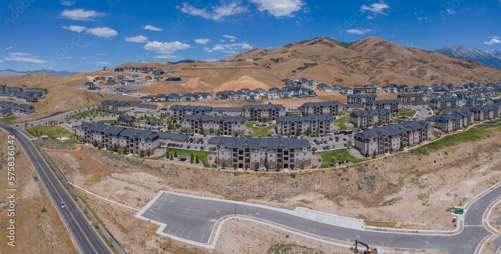 Aerial view of homes in Lehi Utah with blue sky and mountains ...