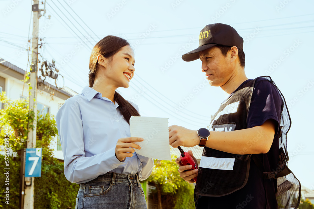 Asian woman handing over piece of paper asking for help from male ...
