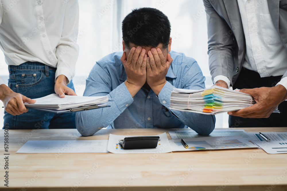 Tired Asian young businessman. Stressed. The man at work has a headache ...