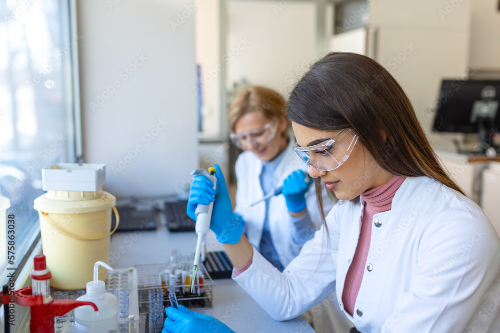 Female Research Scientist Uses Micro Pipette while Working with Test ...