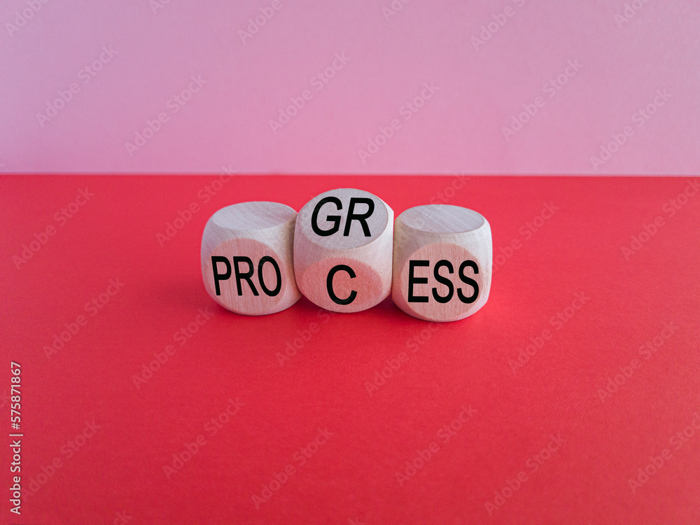 Process and progress symbol. Turned a wooden cube and changes the word ...