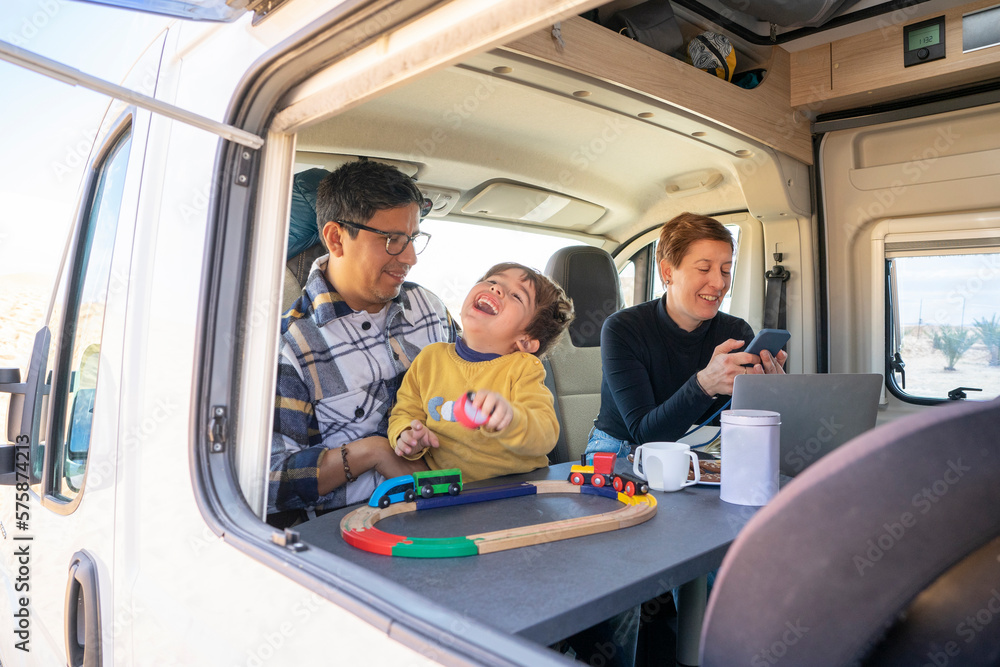 Happy son enjoying with parents in camper van Stock Photo | Adobe Stock