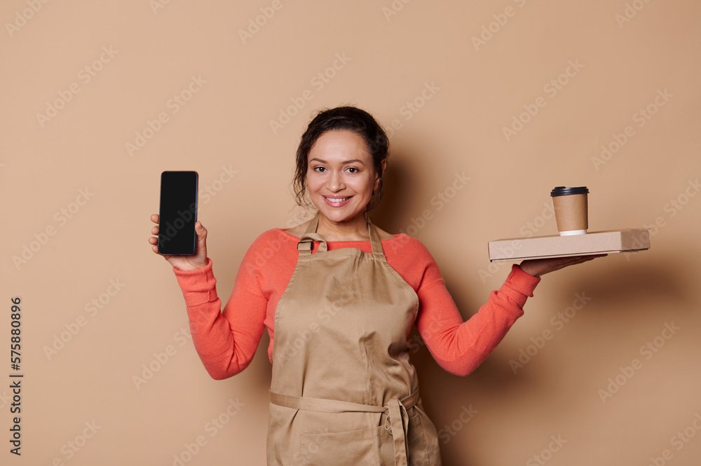 Smiling positive waitress holding takeaway food in disposable cardboard ...