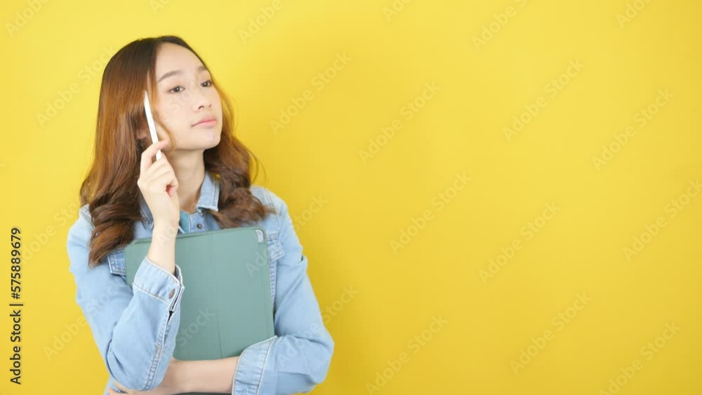 Young beautiful asian woman thinking behind yellow background Stock 비디오 ...
