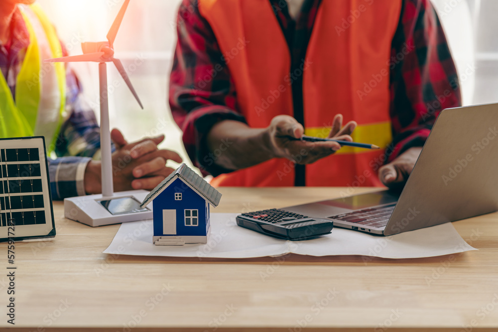 Construction team starts new project plans behind yellow helmets on ...