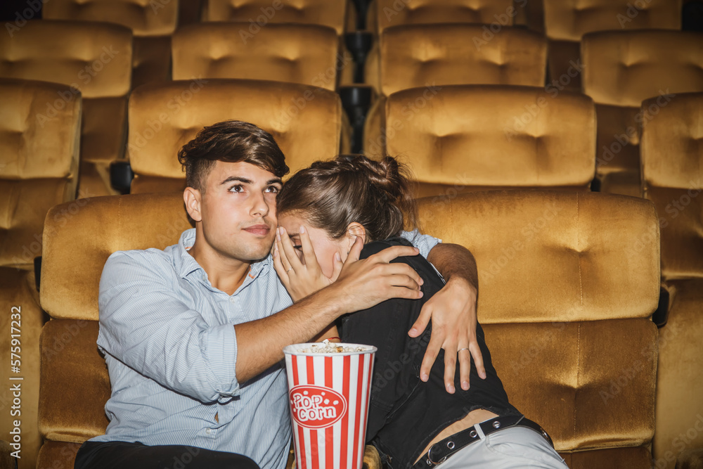 Caucasian couple watching scary horror movie in a multiplex movie ...