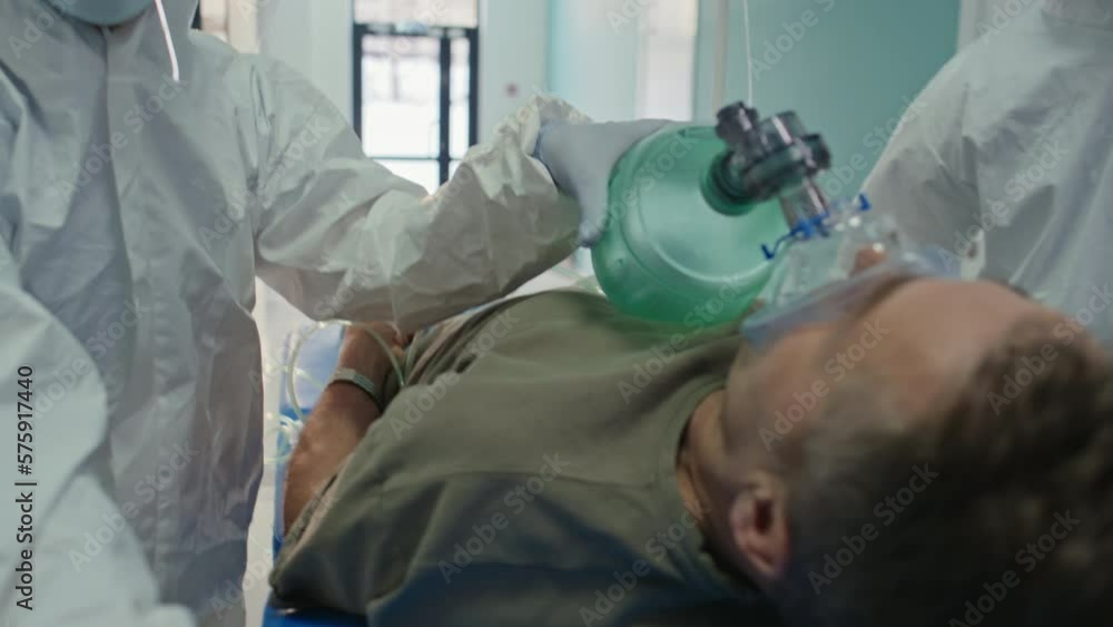 Tracking shot of unrecognizable paramedic service workers performing ...