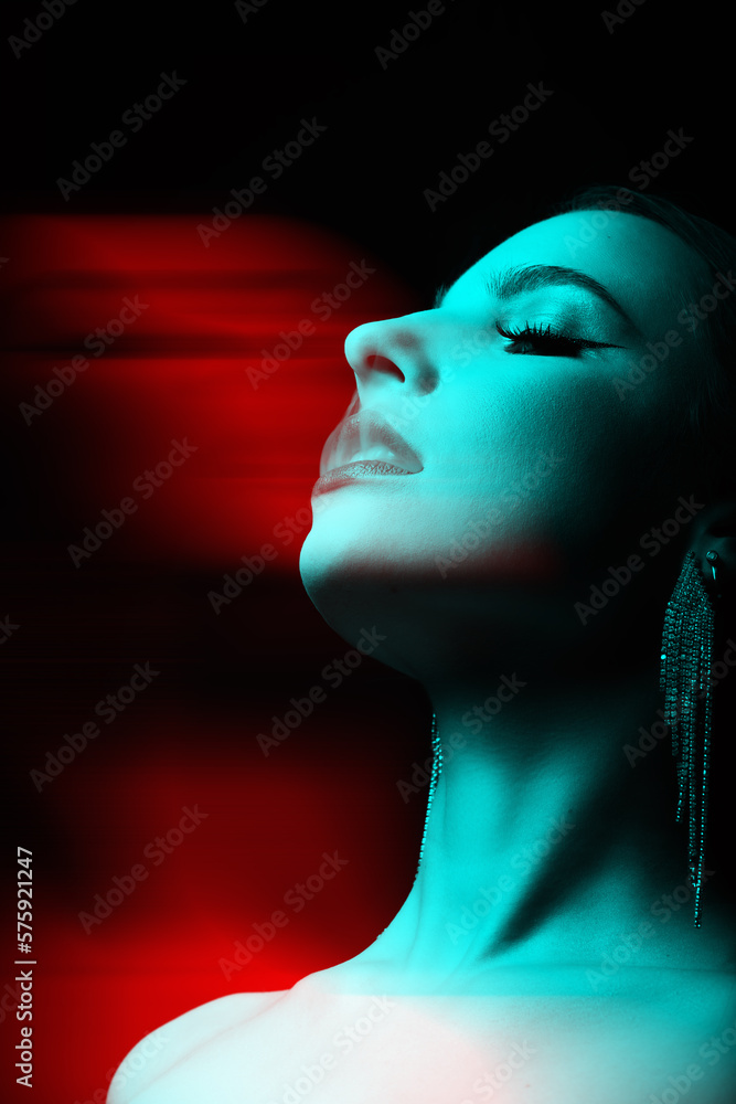 Beautiful woman studio portrait with fancy earrings blowing smoke ...