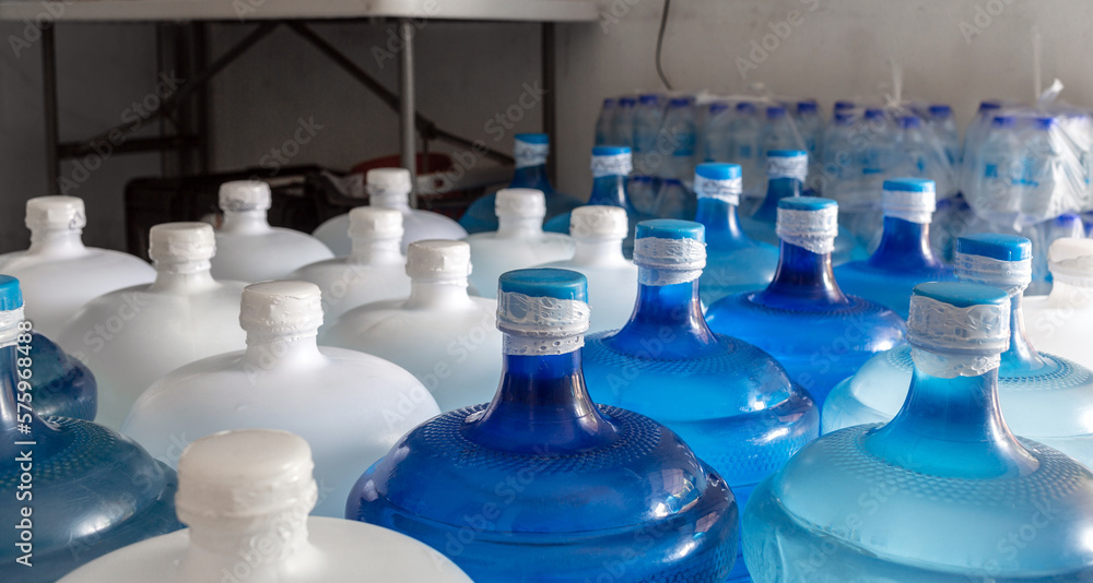 Plastic big bottles or white and blue gallons of purified drinking ...