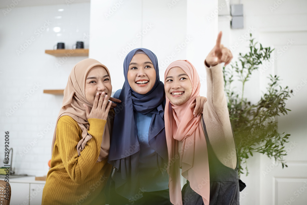 Group of Muslim girl friends express their excitement and surprise at ...