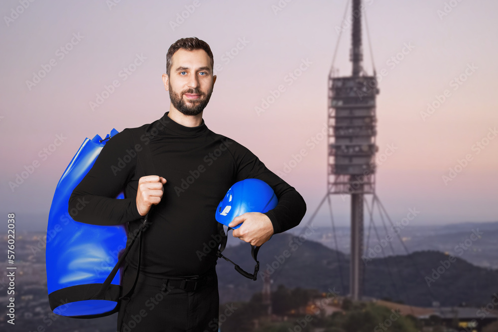 Man, tower worker. Work at height. Radio antenna. With helmet, safety ...